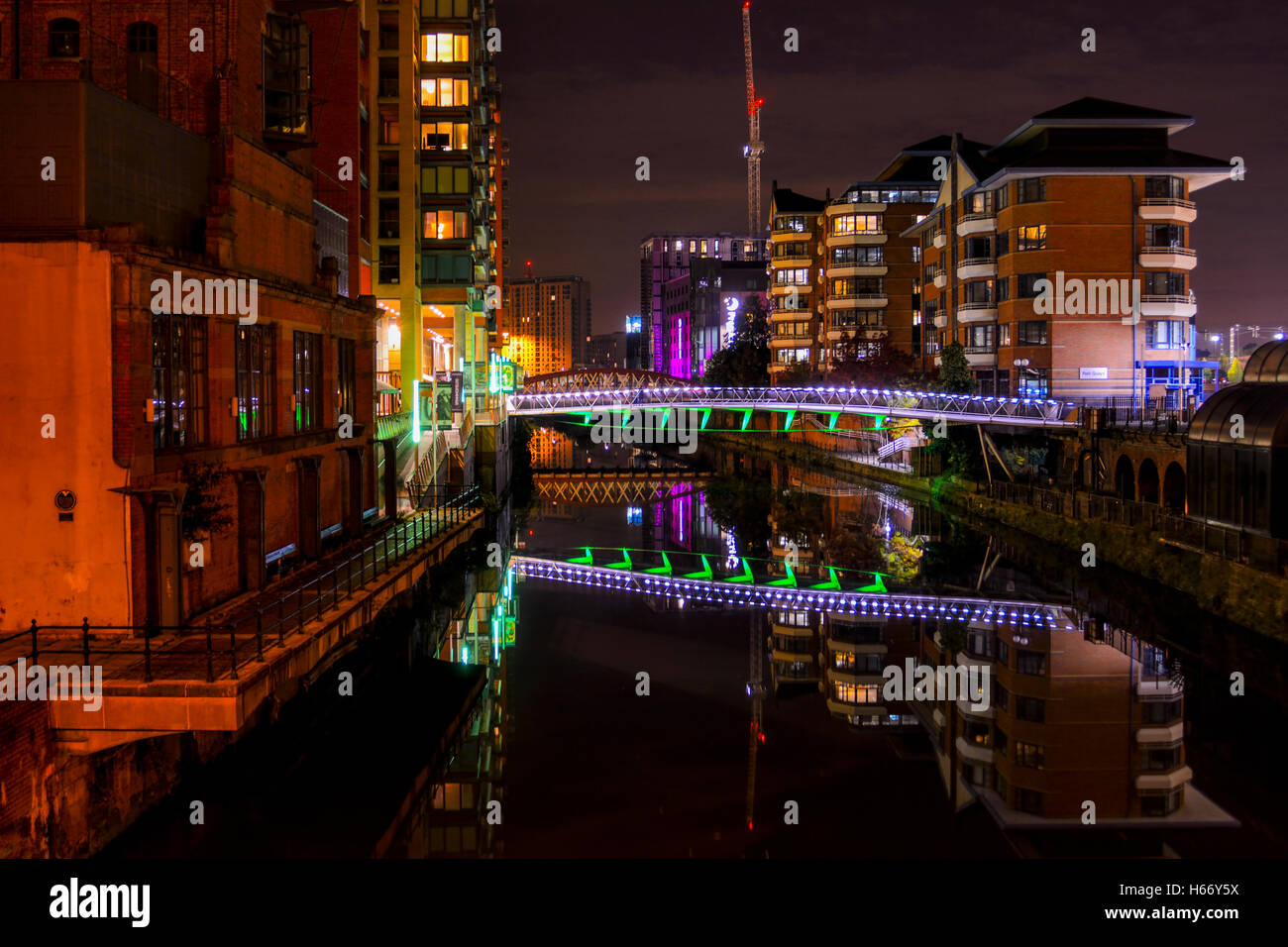 Illuminated footbridge crossing the River Irwell joining Spinningfields ...