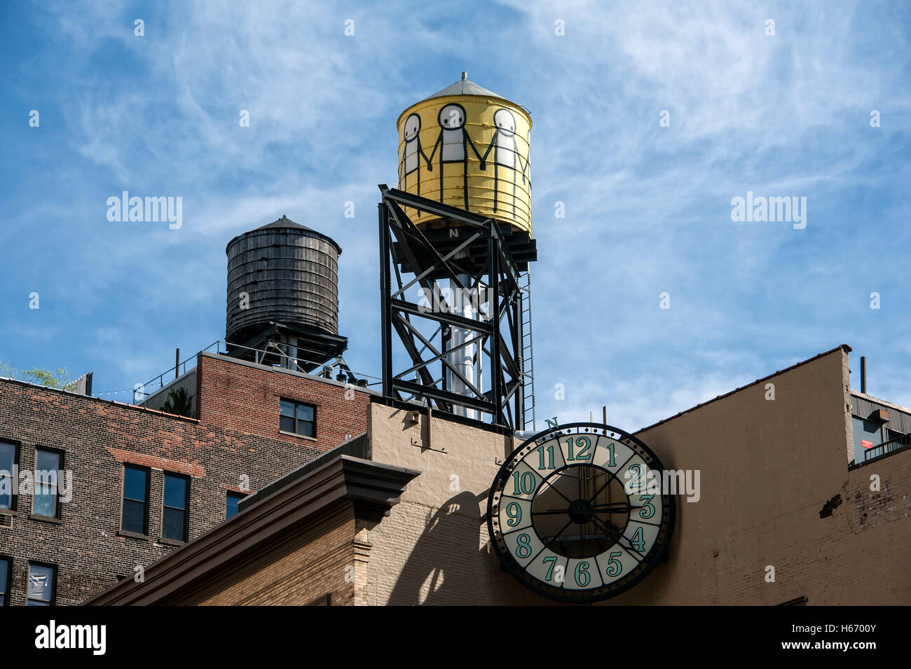 Clock and water tanks on rooftops, Manhattan, New York City Stock Photo ...