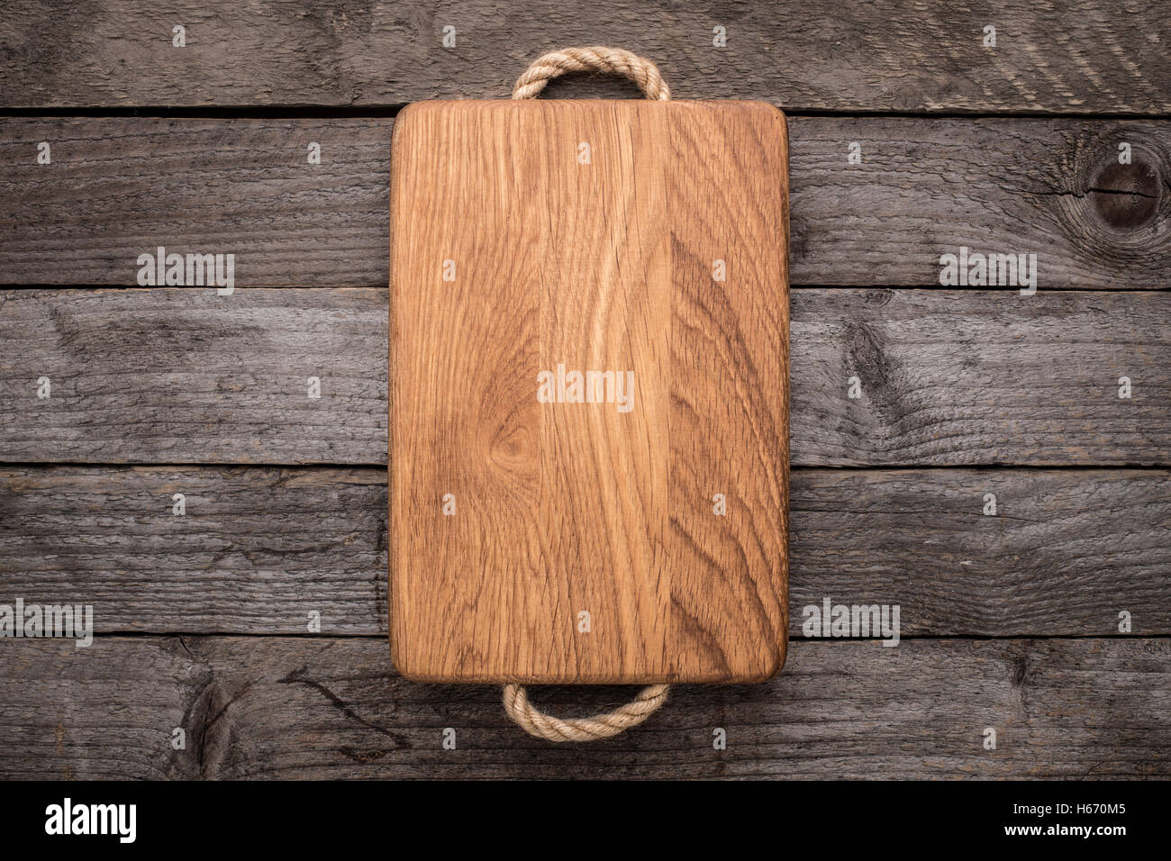 Chopping board on rustic table Stock Photo - Alamy