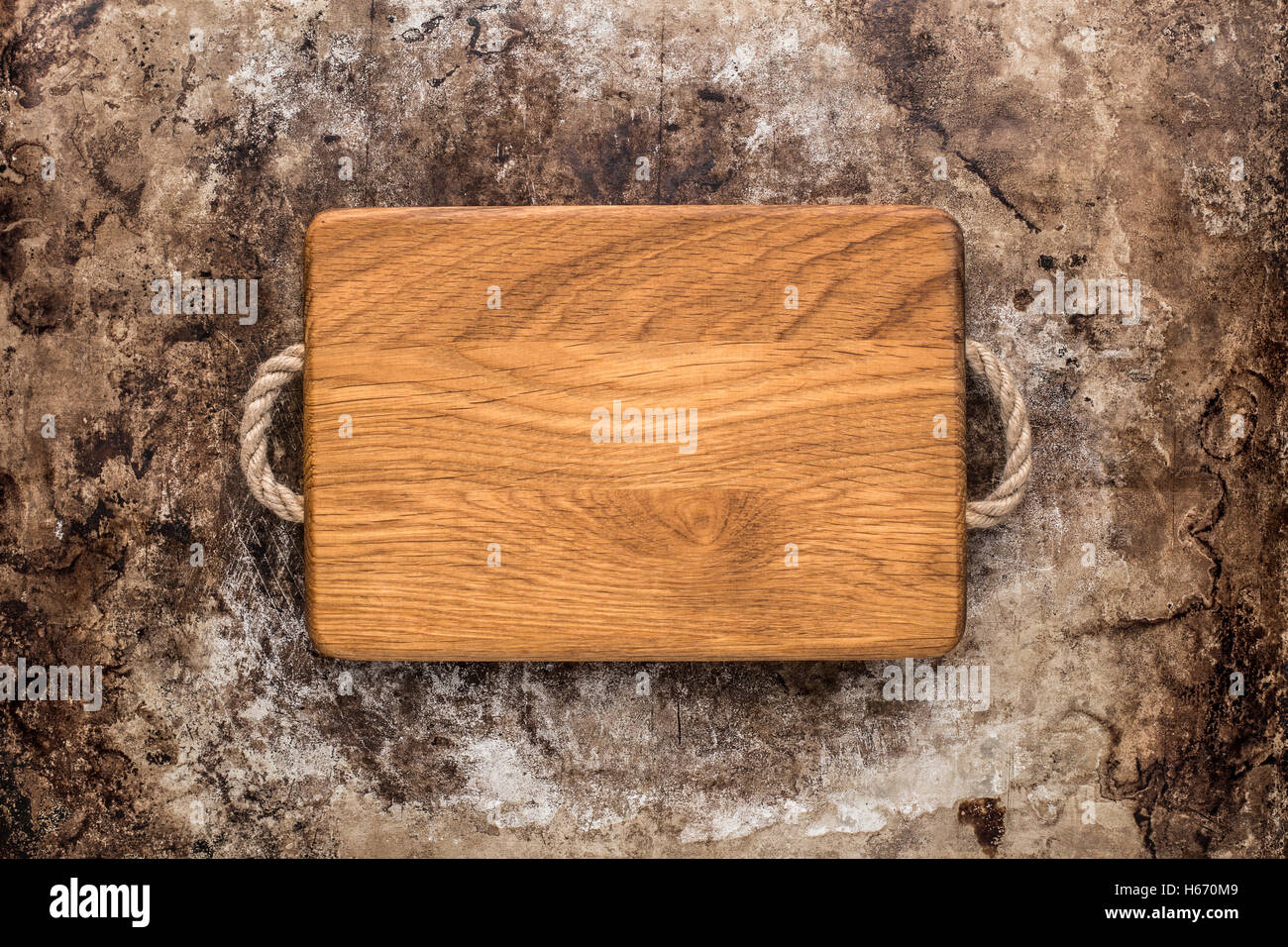 Chopping board on rustic table Stock Photo - Alamy