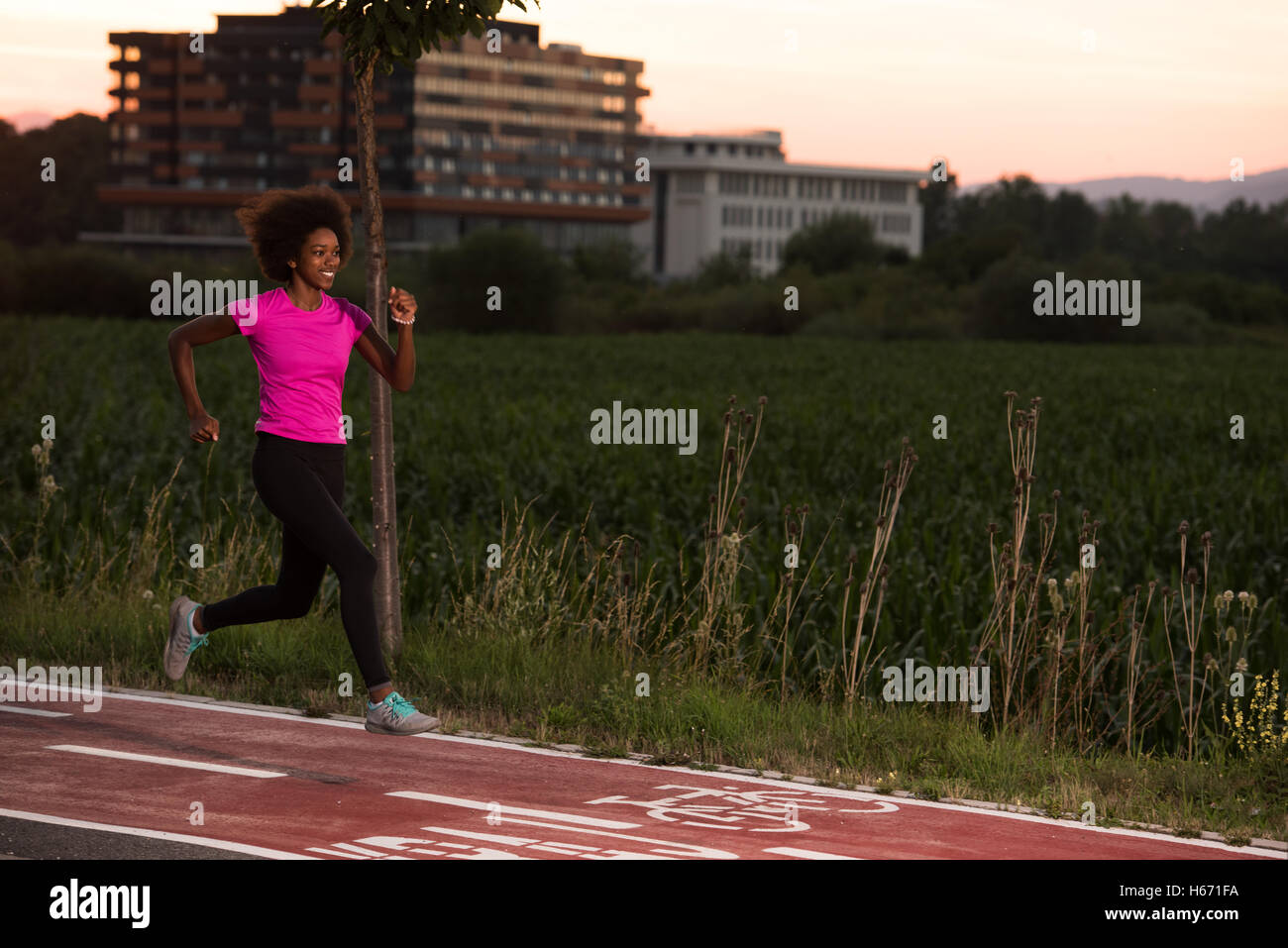 young beautiful African American woman enjoys running outside beautiful ...