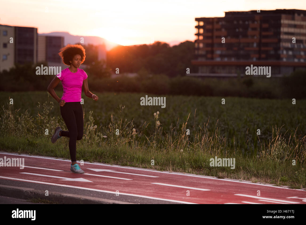 young beautiful African American woman enjoys running outside beautiful ...