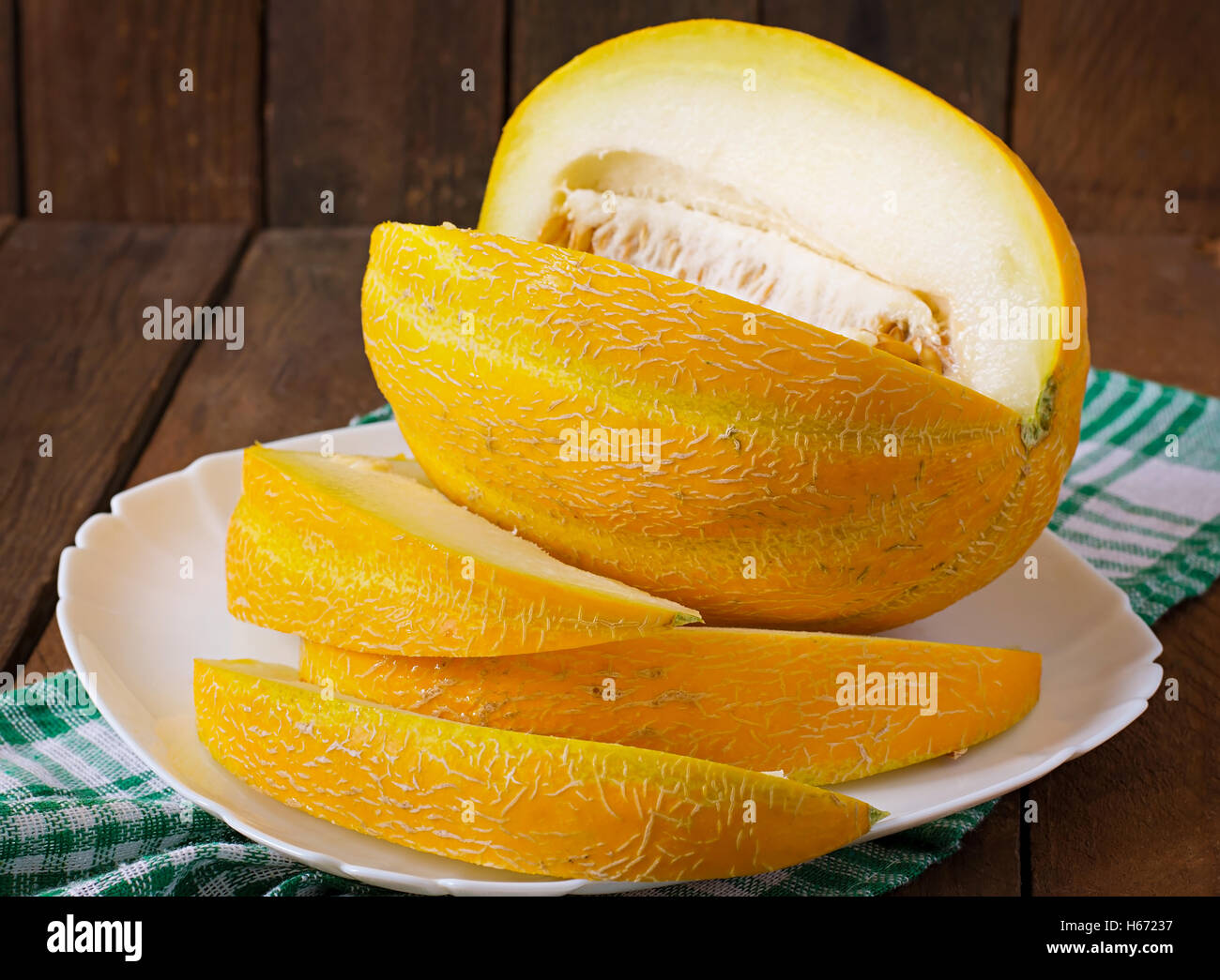 Melon cut into pieces on a plate Stock Photo - Alamy