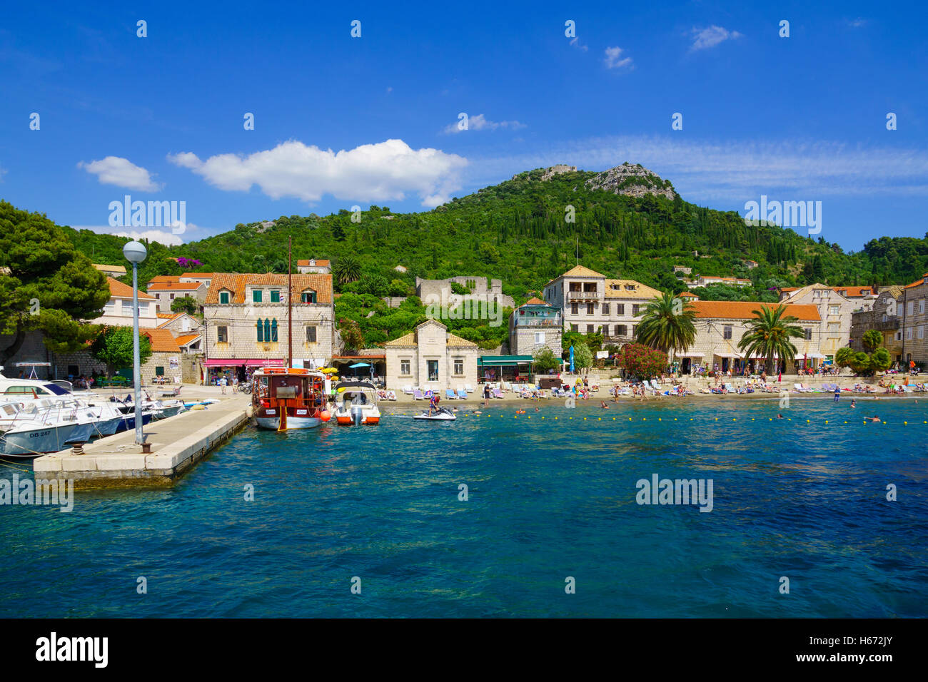 LOPUD, CROATIA - JUNE 27, 2015: Scene of the fishing port and the beach ...