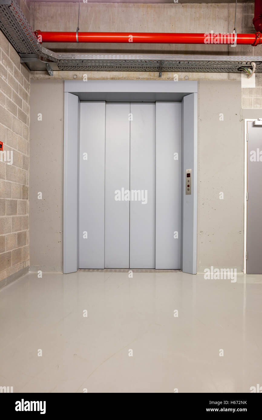 an closed elevator on the first floor of an long corridor Stock Photo ...