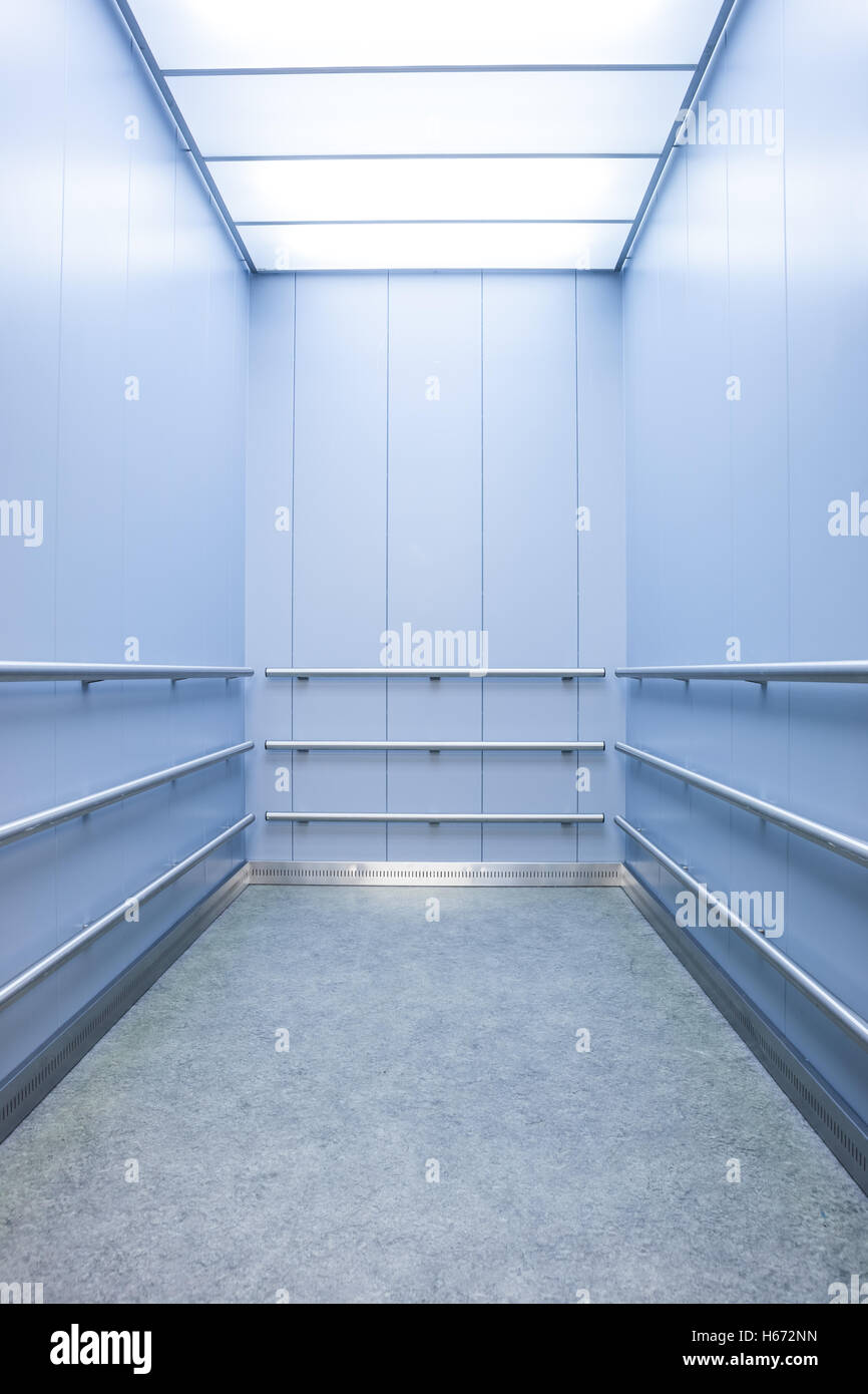 an open elevator on the first floor of an long corridor Stock Photo - Alamy
