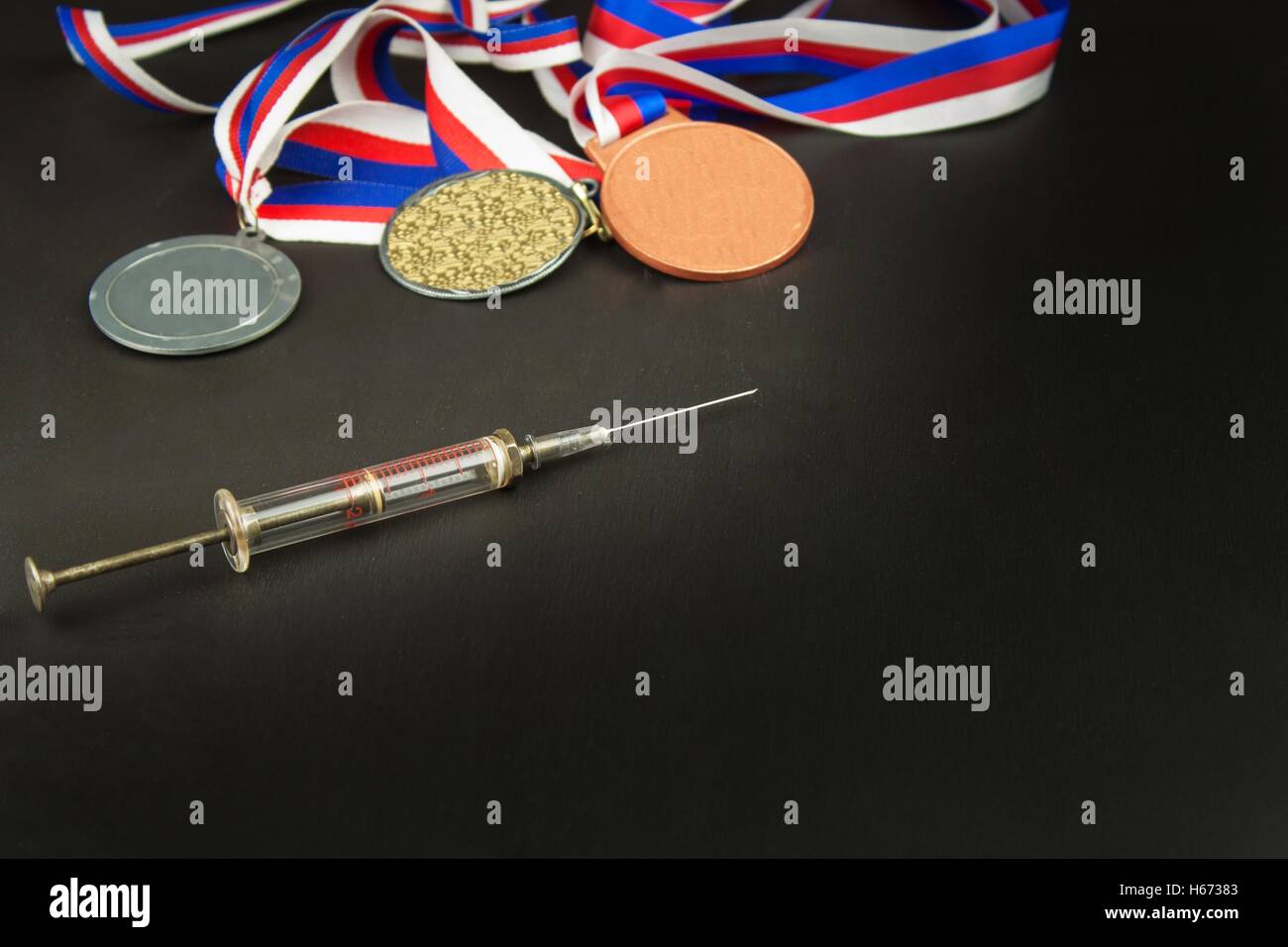 Syringe and medals. Doping in sport. Abuse of anabolic steroids for ...