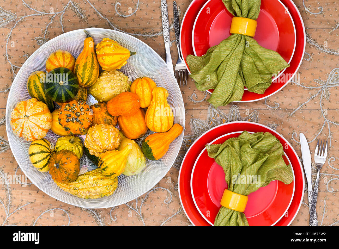 Ornamental fall gourds arranged on a large plate in a table centerpiece ...