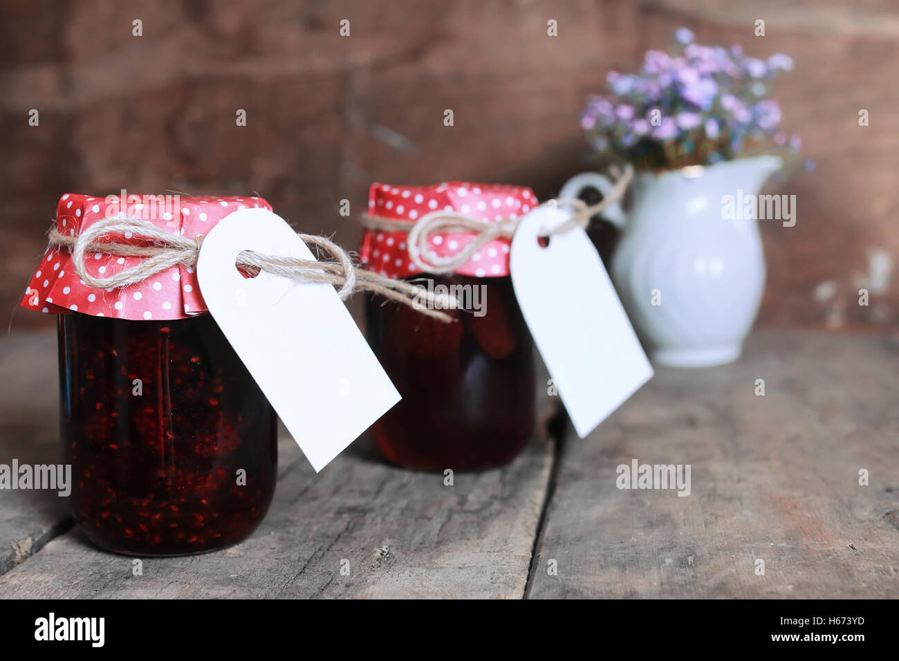 rustic homemade jam jar wooden background and flower Stock Photo - Alamy