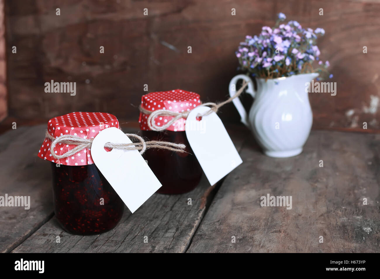 rustic homemade jam jar wooden background and flower Stock Photo - Alamy