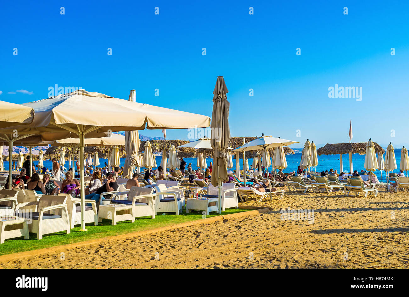 The central beach with the shady summer terrace of the restaurant and ...