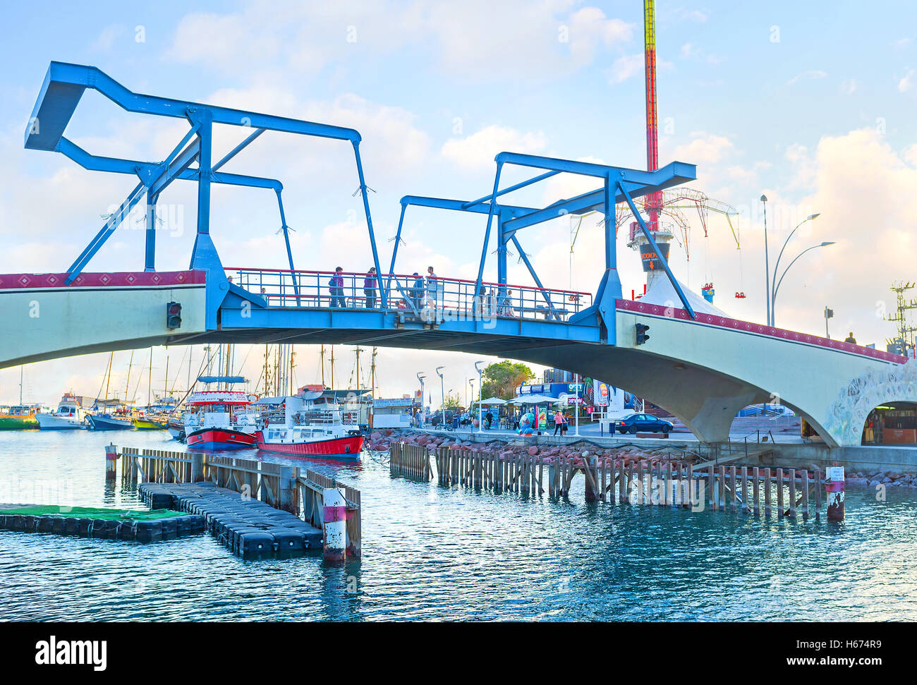 The modern drawbridge over the entrance to the marina with the yachts ...