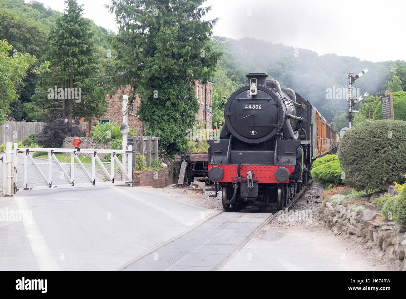 Steam train crosses level crossing on the nymr railway north yorkshire ...