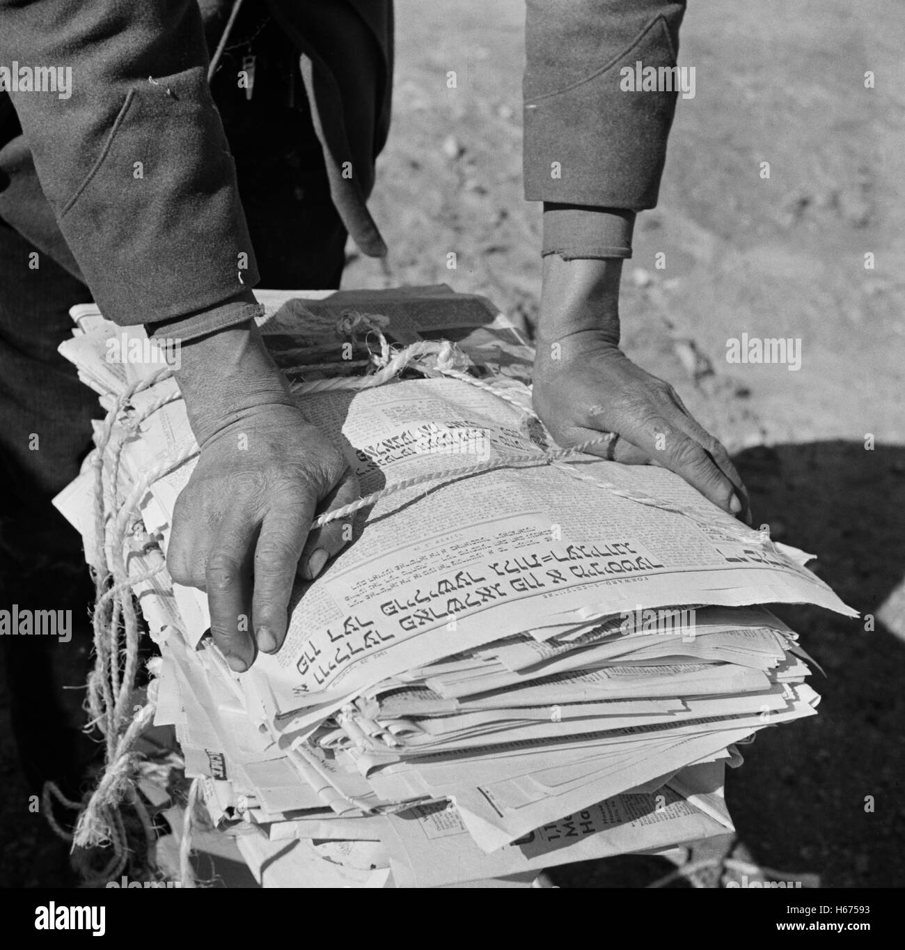 Hands of Government Salvage Collector Wrapping Old Newspapers he had ...