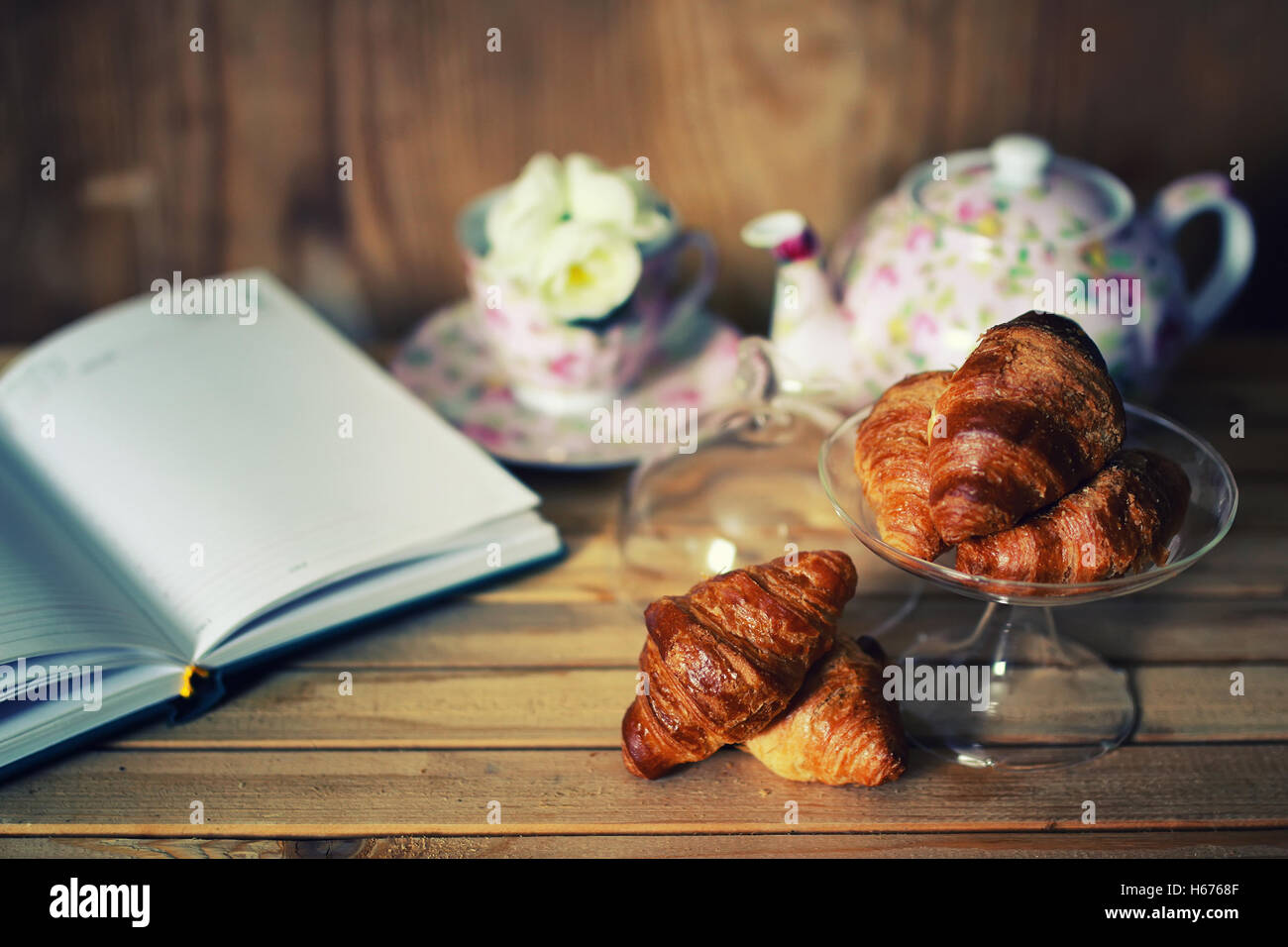 tea cup croissant book Stock Photo - Alamy