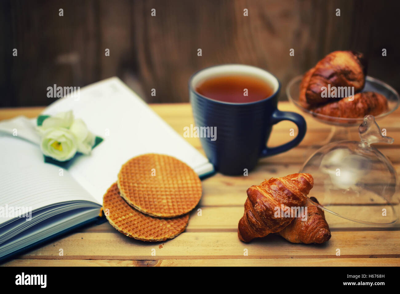 tea cup croissant book Stock Photo - Alamy