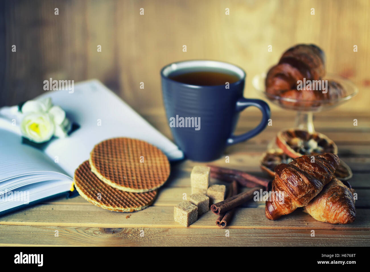 tea cup croissant book Stock Photo - Alamy