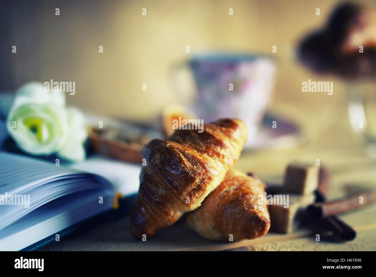 tea cup croissant book Stock Photo - Alamy