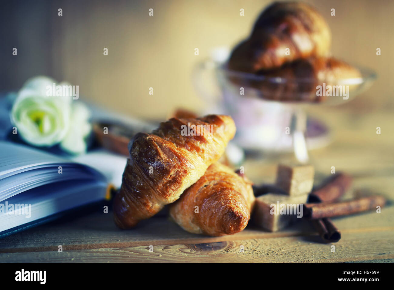 tea cup croissant book Stock Photo - Alamy