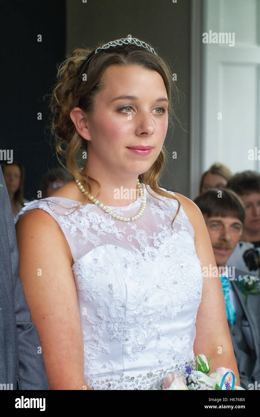 Bride on her wedding day, during the ceremony where she is getting ...
