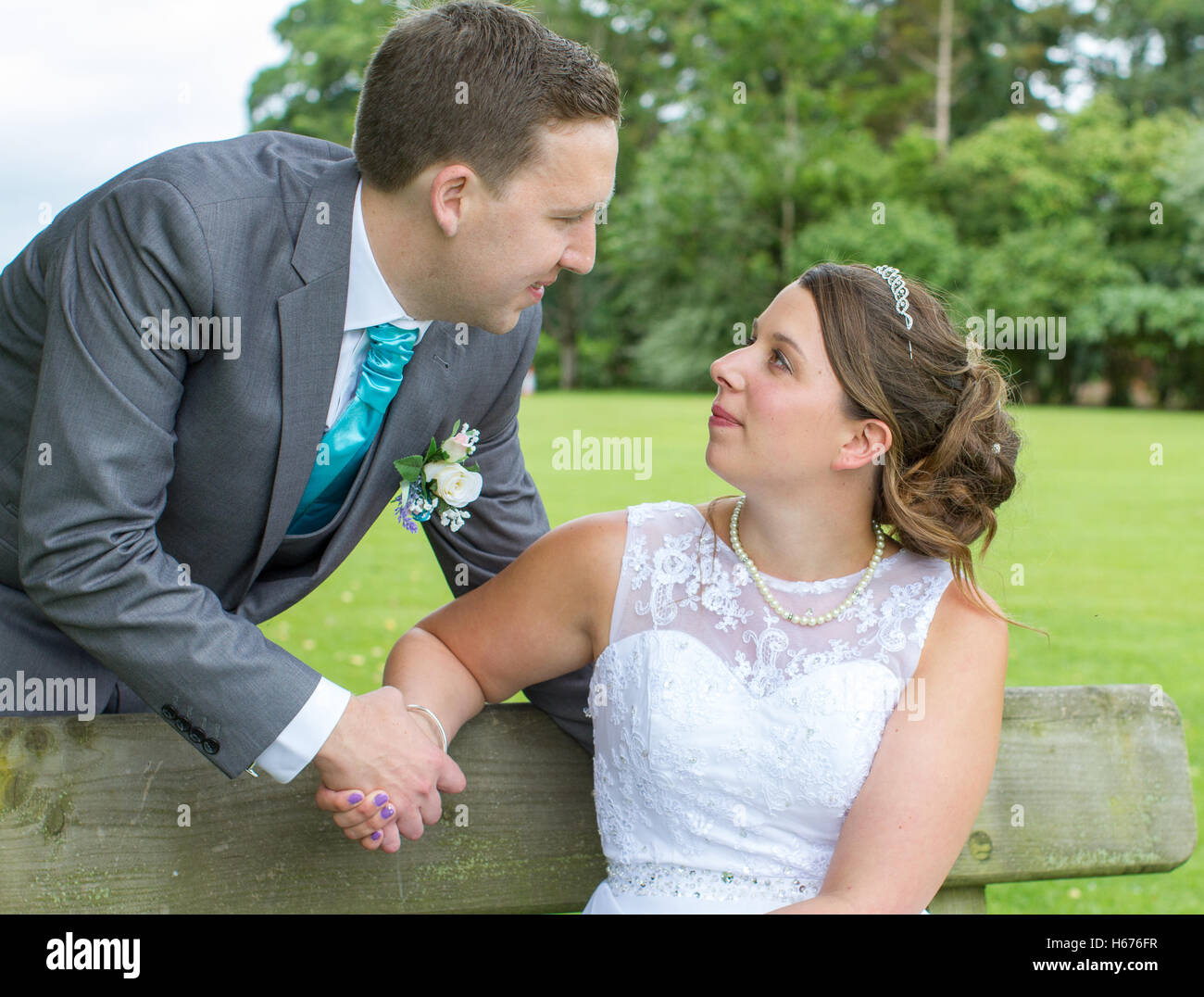 Newly wed husband and wife having formal photos taken at their wedding ...
