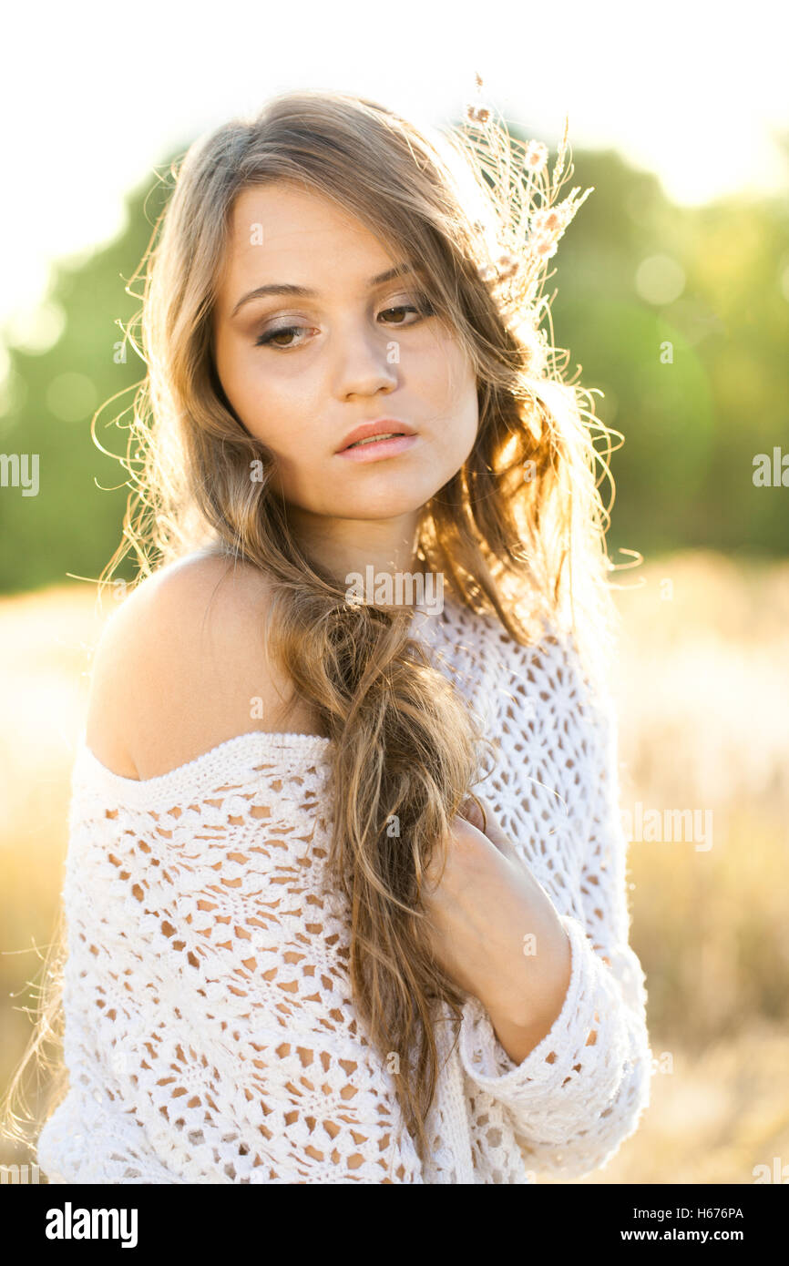 Beautiful model in an open field at sunrise Stock Photo - Alamy