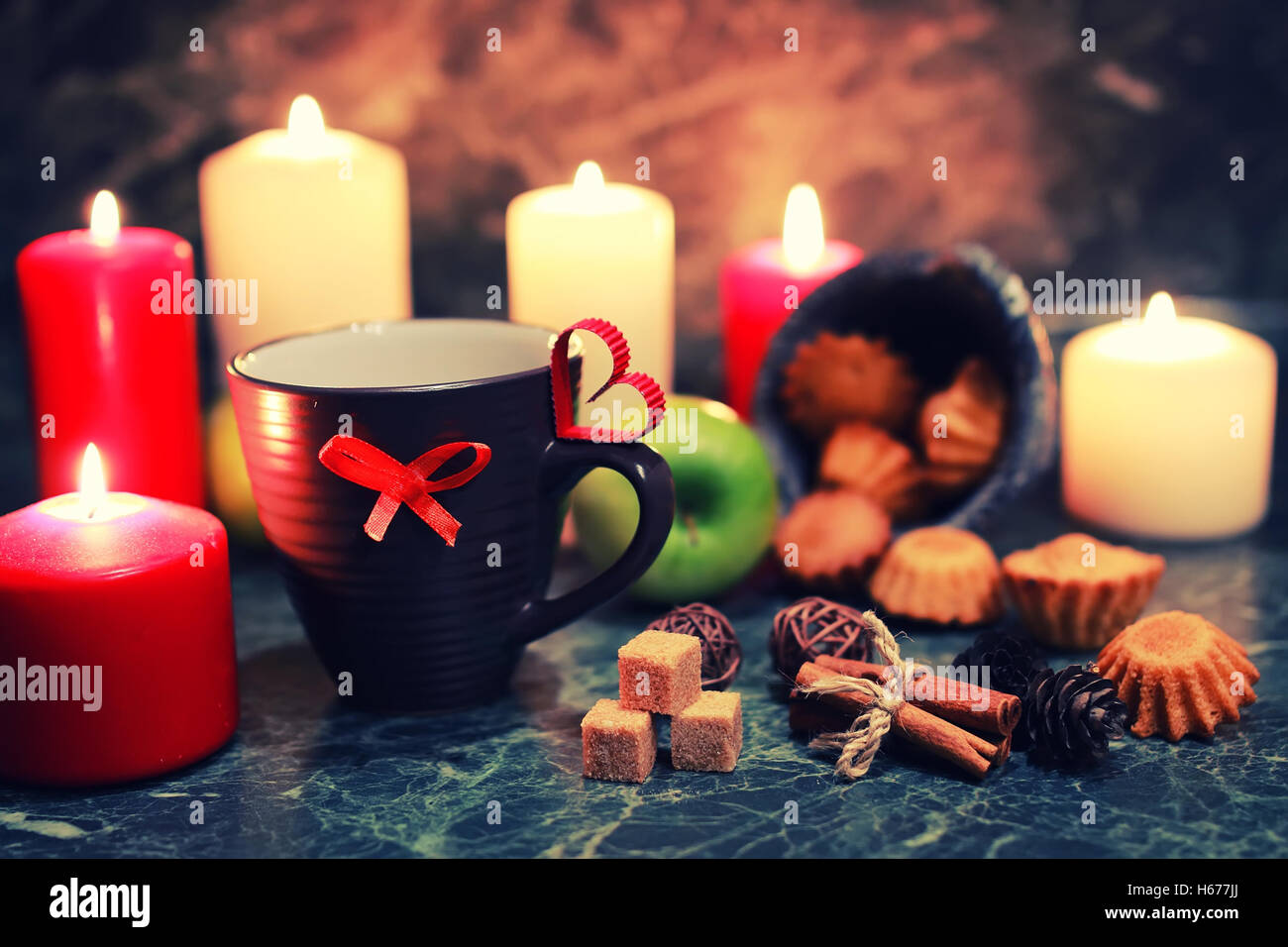night table with mug and candle Stock Photo - Alamy