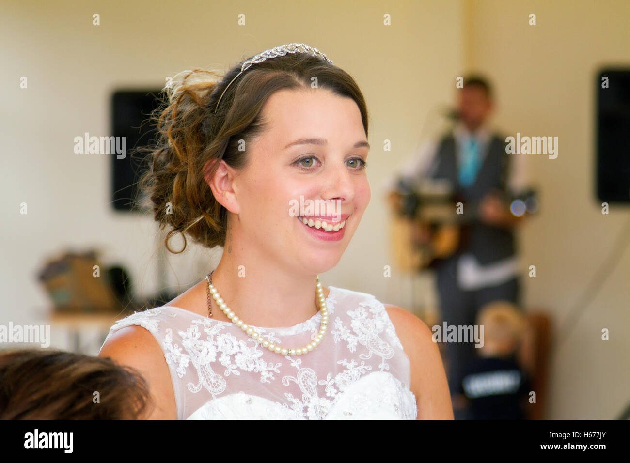 Smiling bride during her wedding reception party, with live band ...