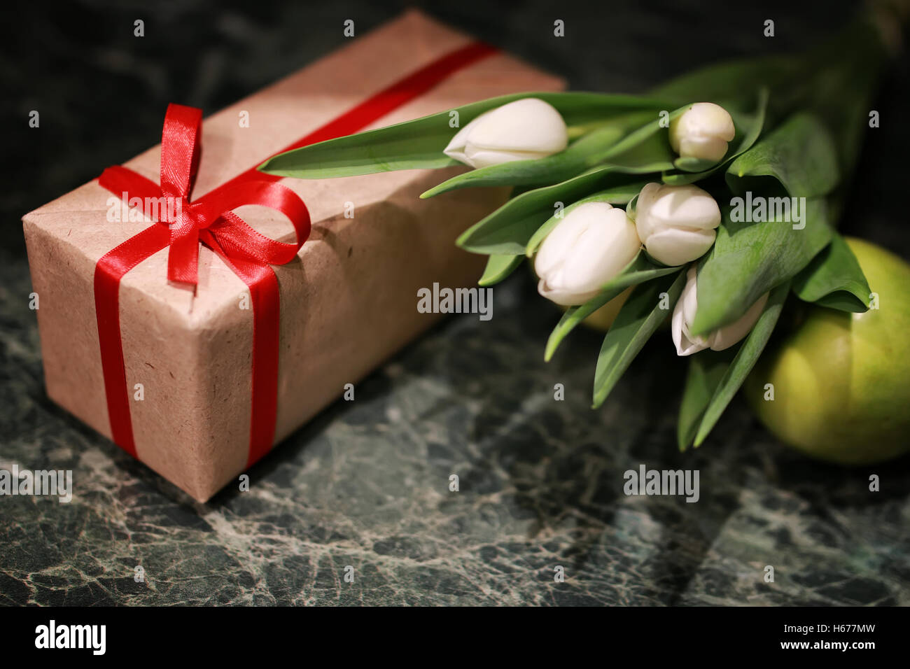 white tulip gift box green background Stock Photo - Alamy