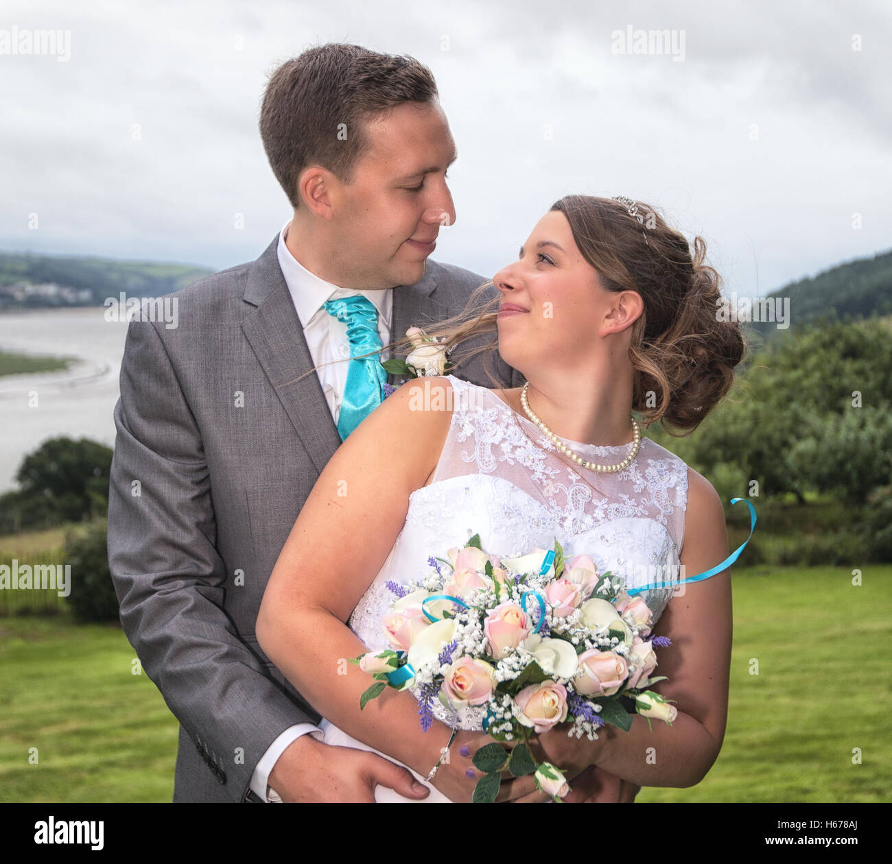 Newly wed husband and wife having formal photos taken at their wedding ...