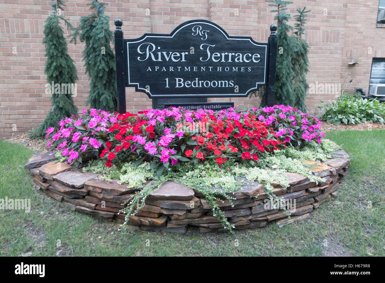 River Terrace apartment rental sign imbedded in a beautiful garden of ...
