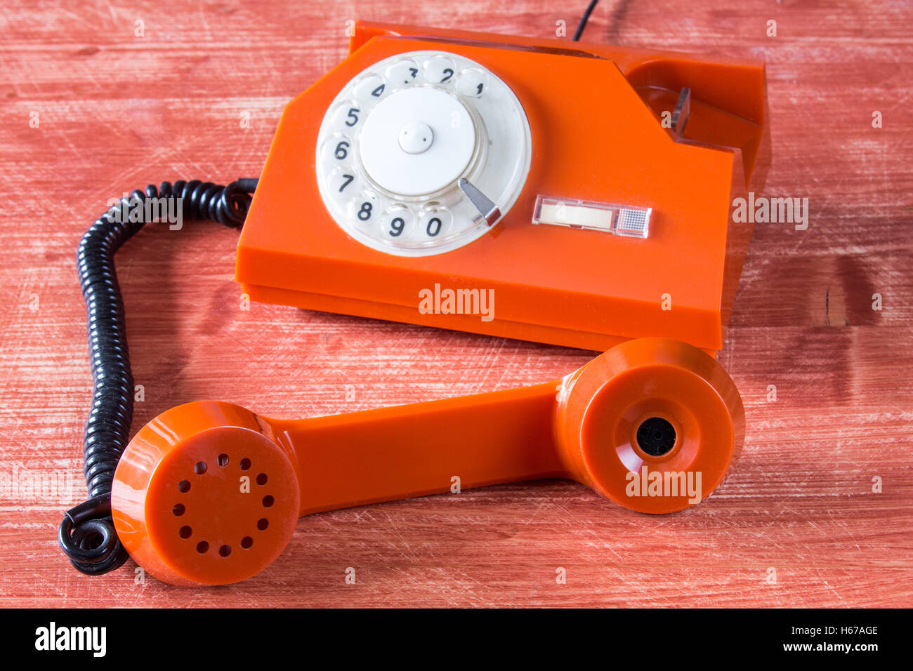 Old orange retro phone with rotary dial Stock Photo - Alamy