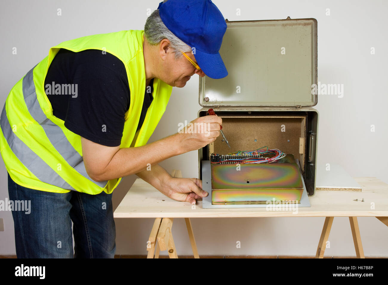 electrician at work with an electronic device Stock Photo - Alamy