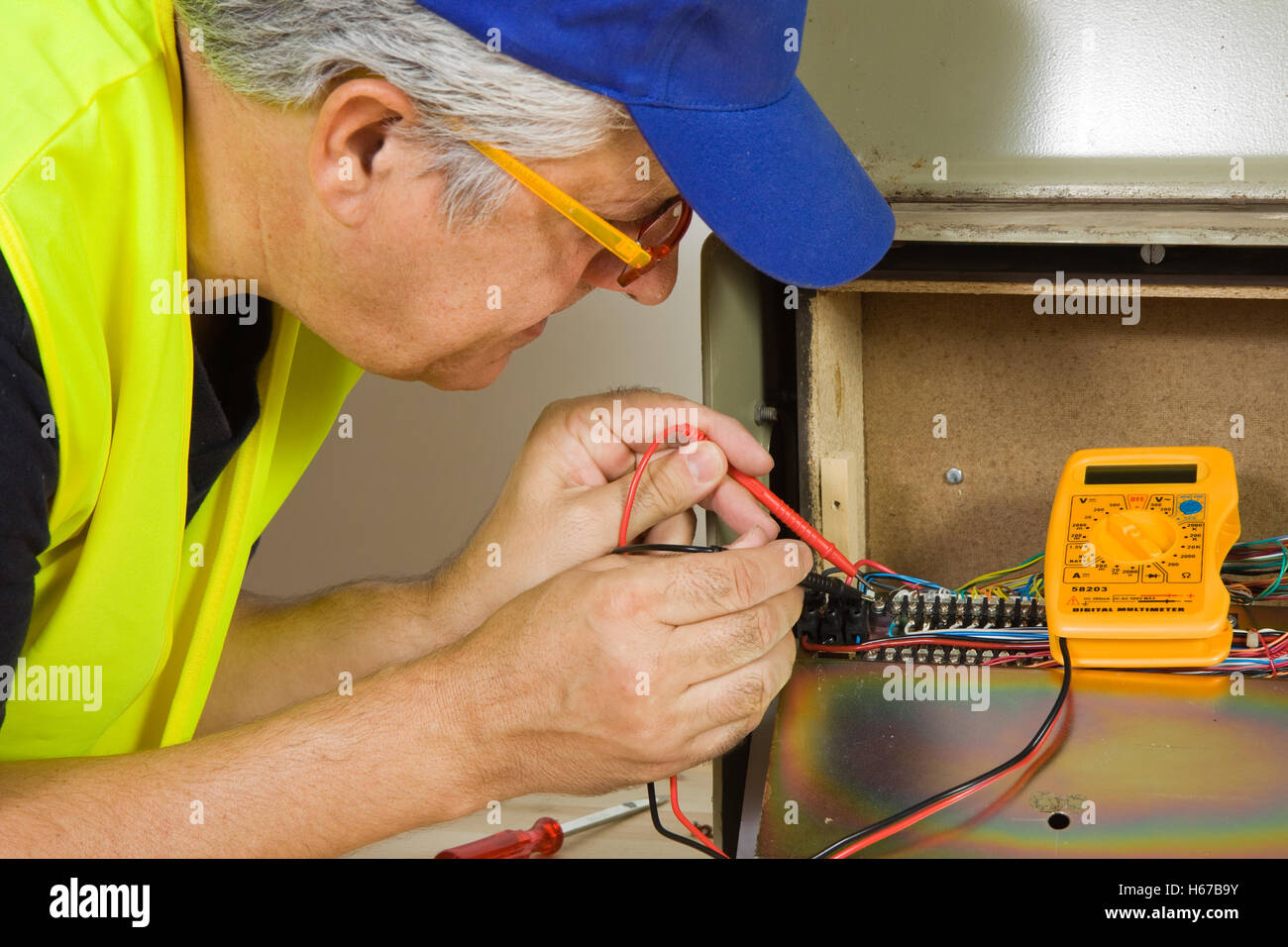 electrician at work with an electronic device Stock Photo - Alamy