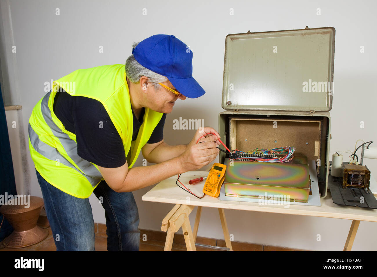 electrician at work with an electronic device Stock Photo - Alamy