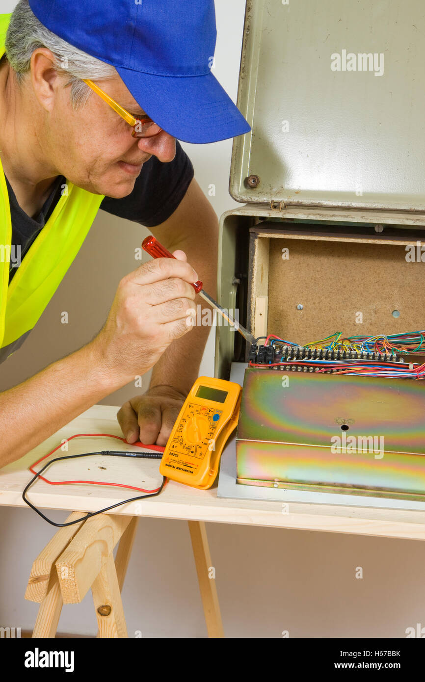 electrician at work with an electronic device Stock Photo - Alamy