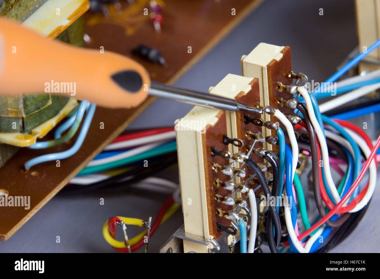 electrician at work with an electric device Stock Photo - Alamy