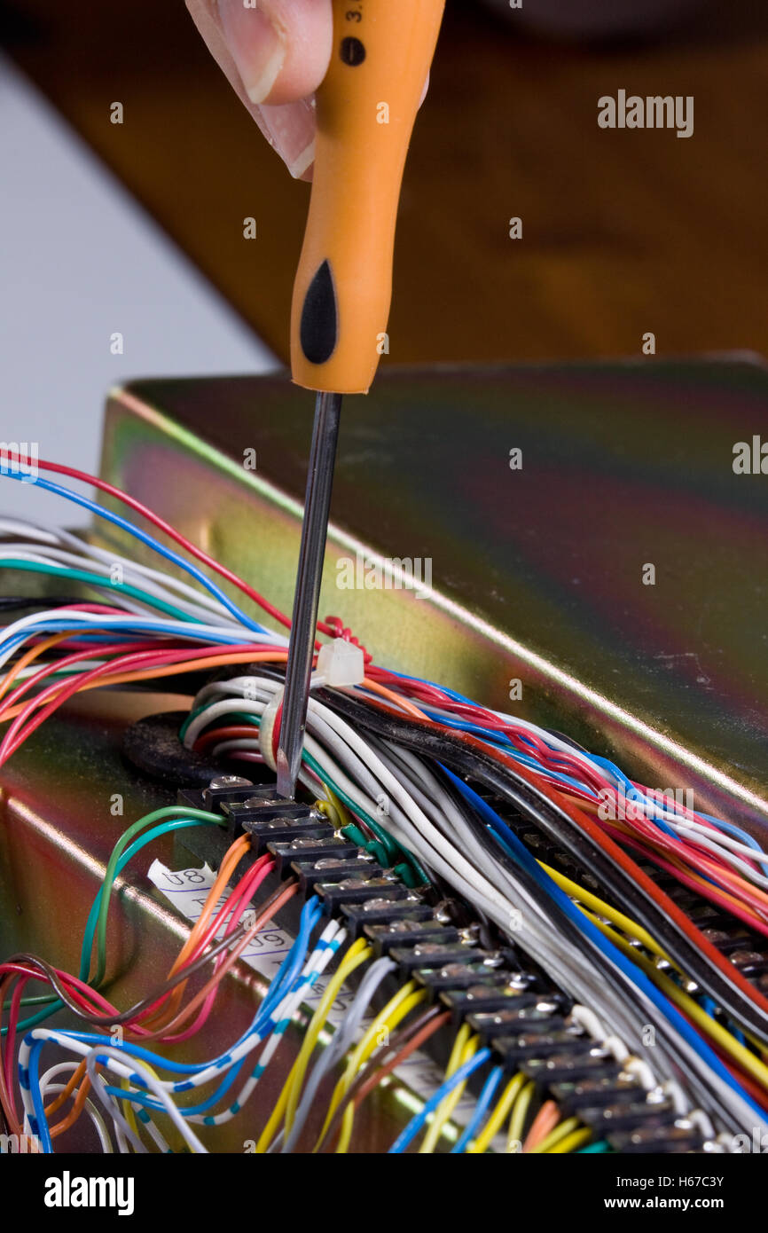electrician at work with an electric device Stock Photo - Alamy