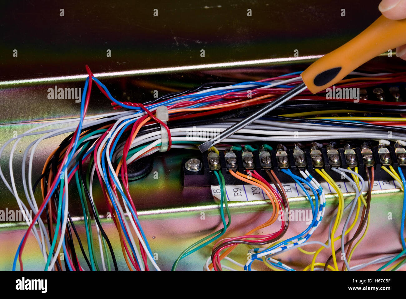 electrician at work with an electric device Stock Photo - Alamy