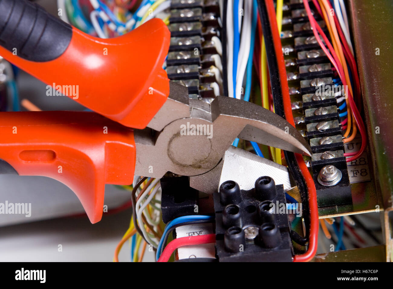electrician at work with an electric device Stock Photo - Alamy