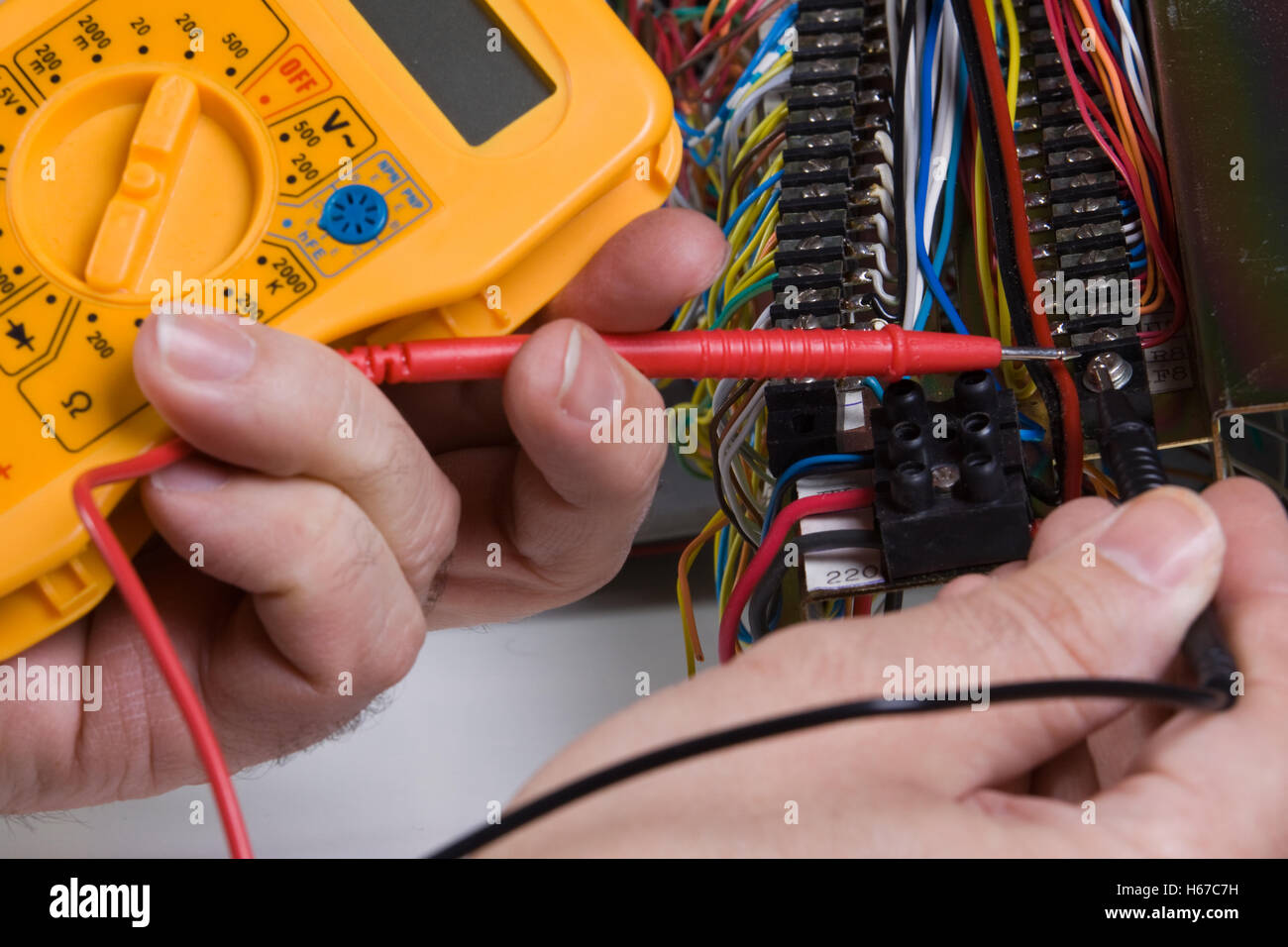 electrician at work with an electric device Stock Photo - Alamy