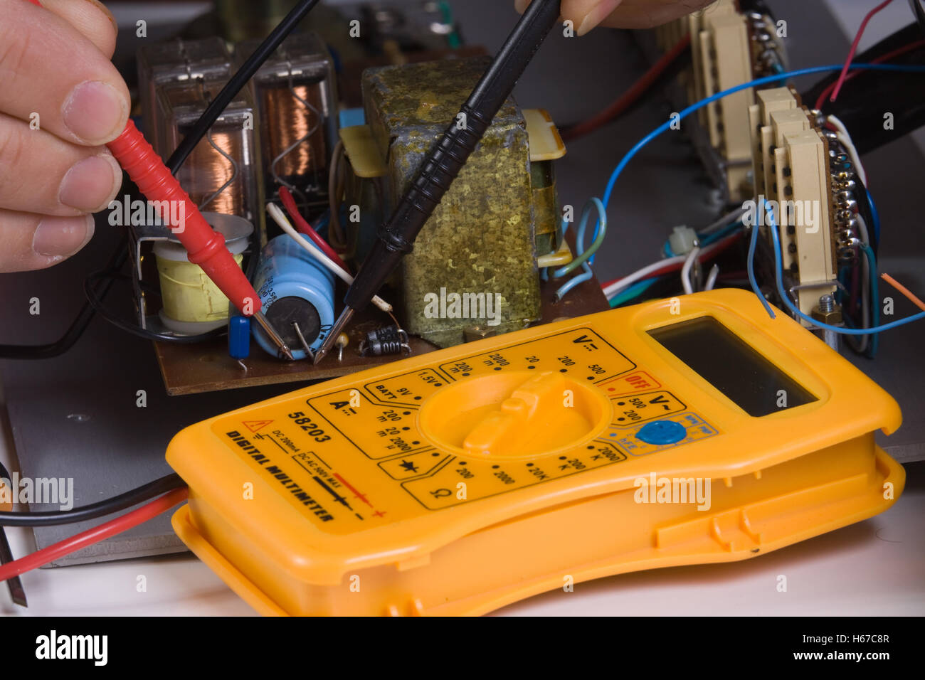 electrician at work with an electric device Stock Photo - Alamy