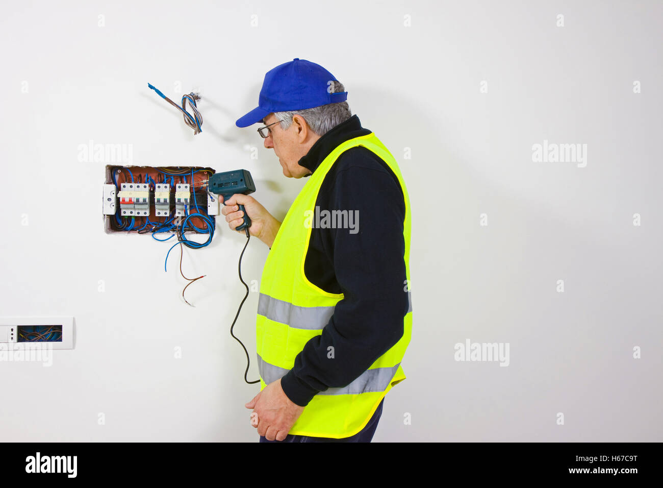 electrician at work in a building site Stock Photo - Alamy