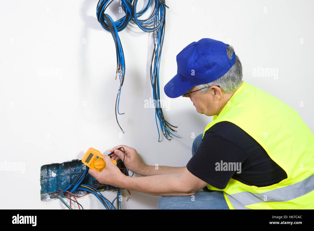 electrician at work in a building site Stock Photo - Alamy