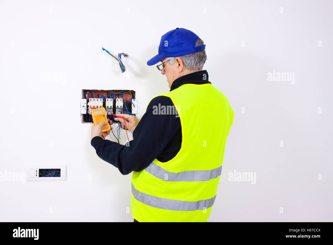 electrician at work in a building site Stock Photo - Alamy
