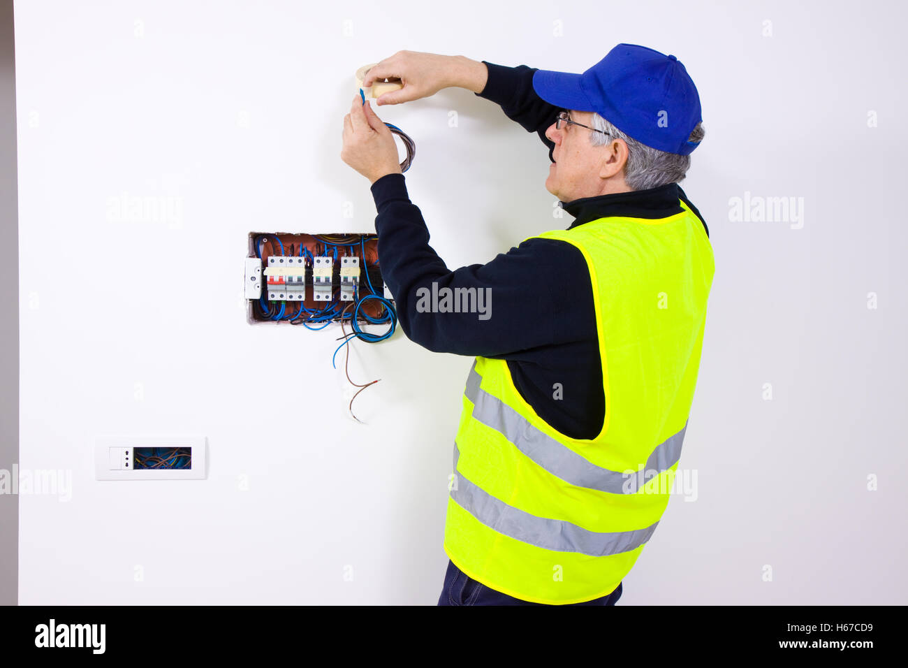 electrician at work in a building site Stock Photo - Alamy