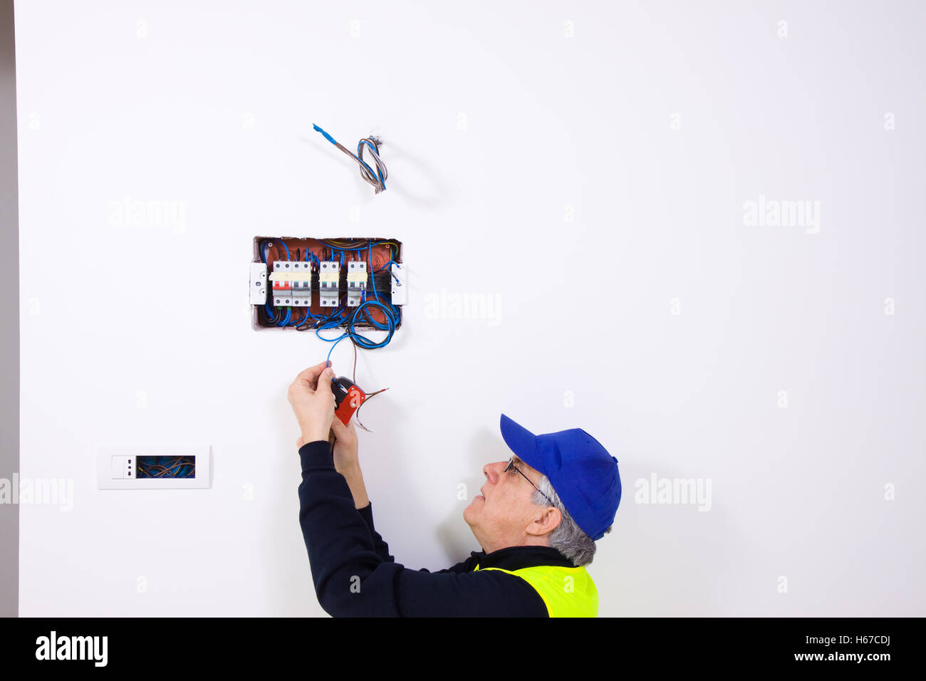 electrician at work in a building site Stock Photo - Alamy