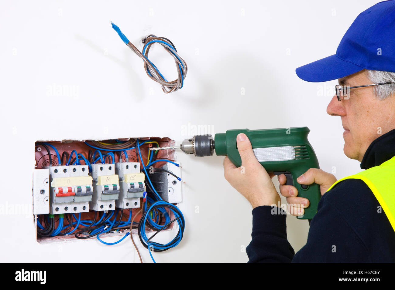 electrician at work in a building site Stock Photo - Alamy
