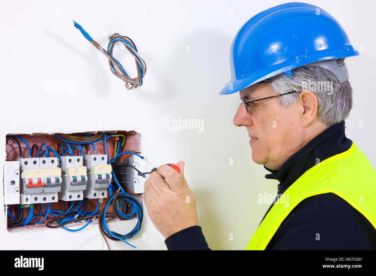 electrician at work in a building site Stock Photo - Alamy