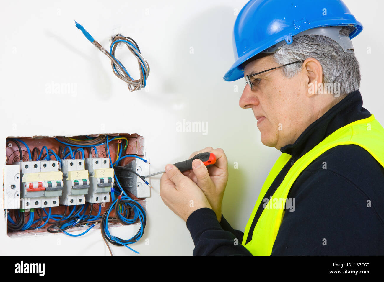 electrician at work in a building site Stock Photo - Alamy